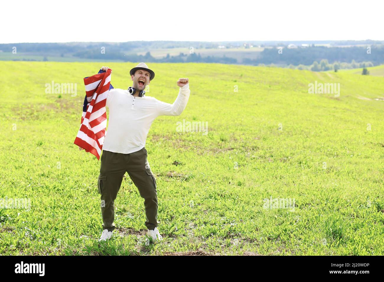 Man waving American flag standing in farm agricultural field , holidays ...