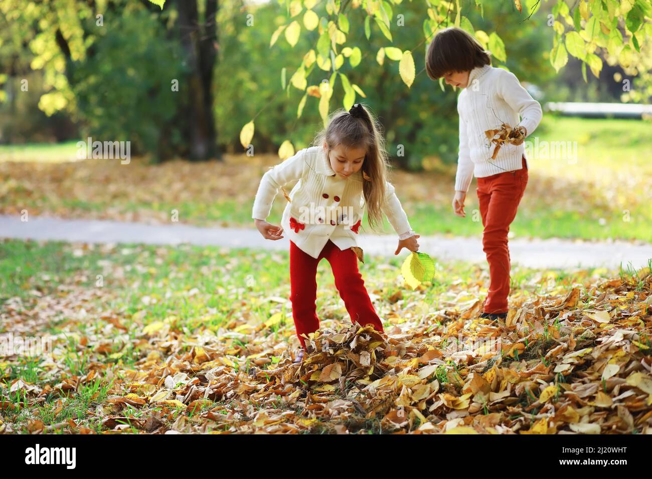 Children for a walk in autumn park. Leaf fall in the park. Family. Fall ...