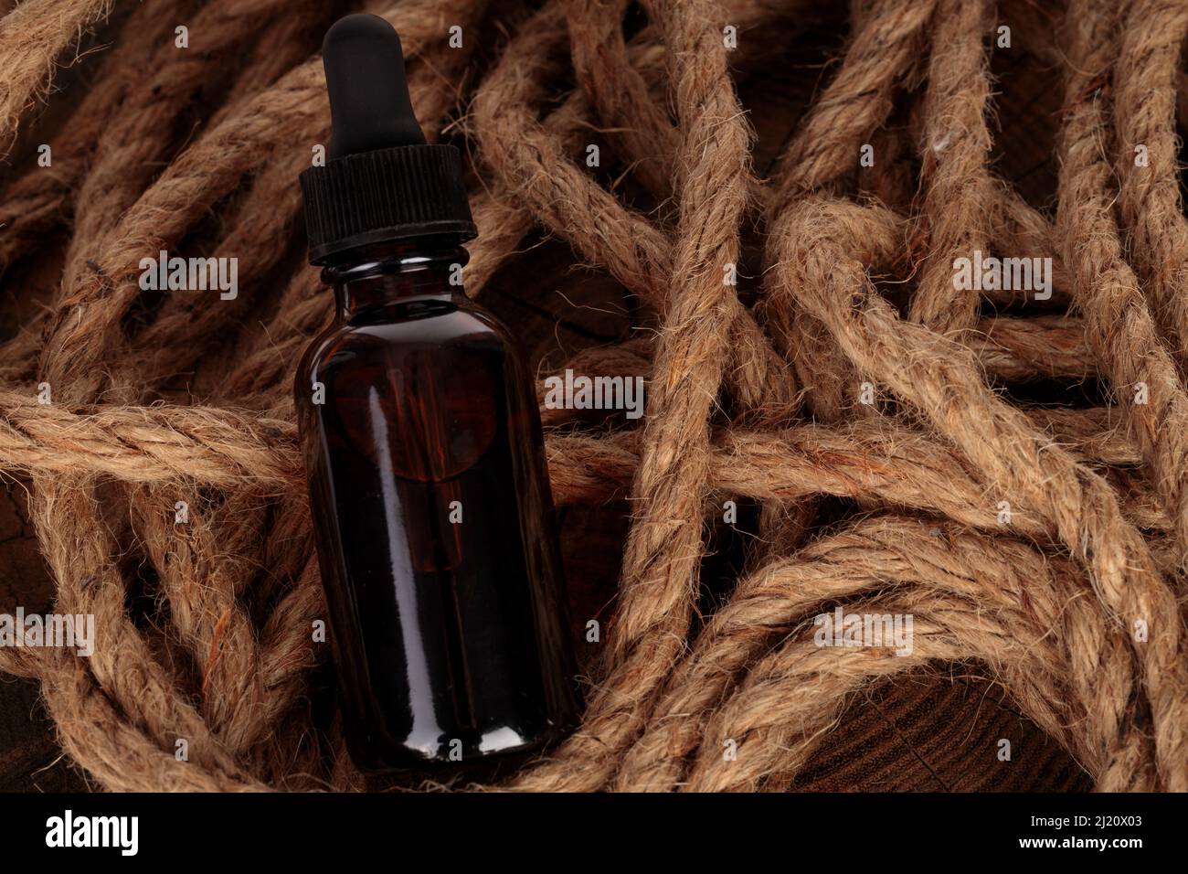 Dropper bottle on rolled ropes. Oil for beard, mock-up. Flatly Stock ...