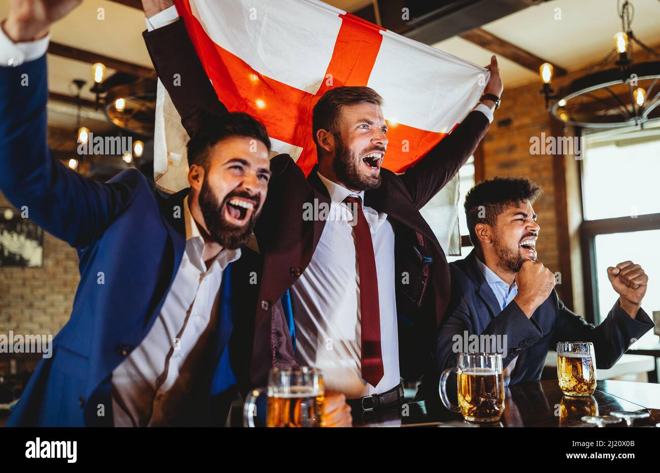 Business men in pub cheering for a sporting event Stock Photo - Alamy
