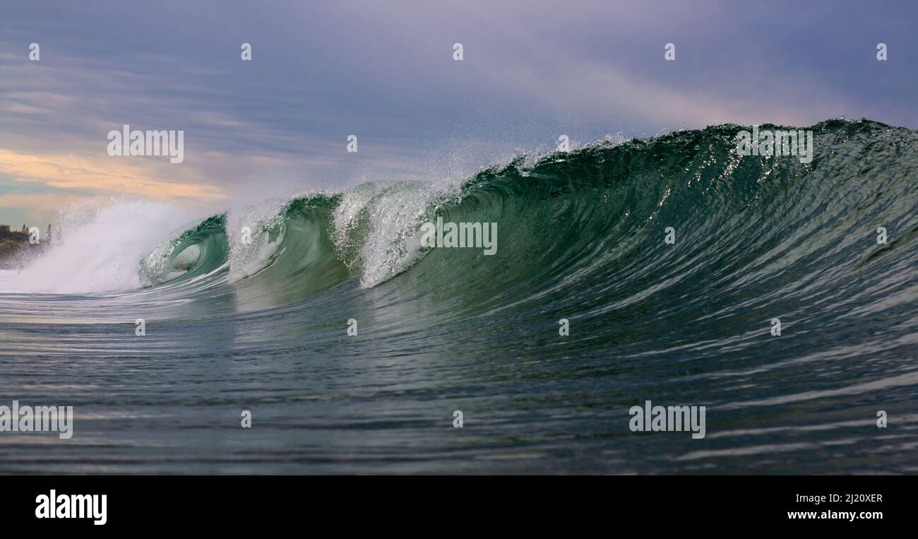 Green wave gones alone Stock Photo - Alamy