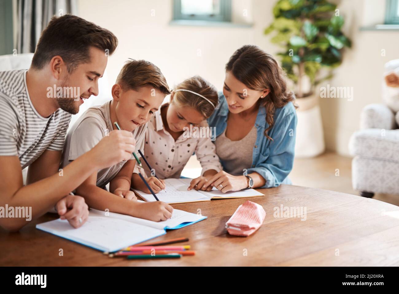 The family who learns together grows together. Shot of a happy young ...