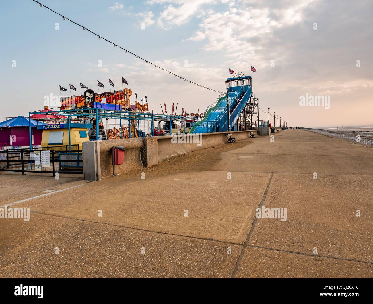 The funfair beside the promenade or esplanade in the seaside town of ...