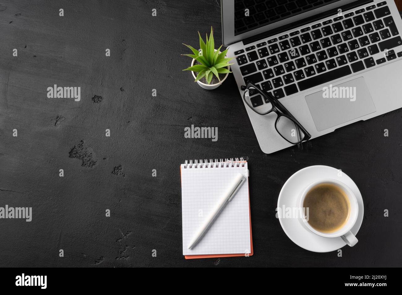 Notepad is on top of office desk table with laptop and supplies Stock ...