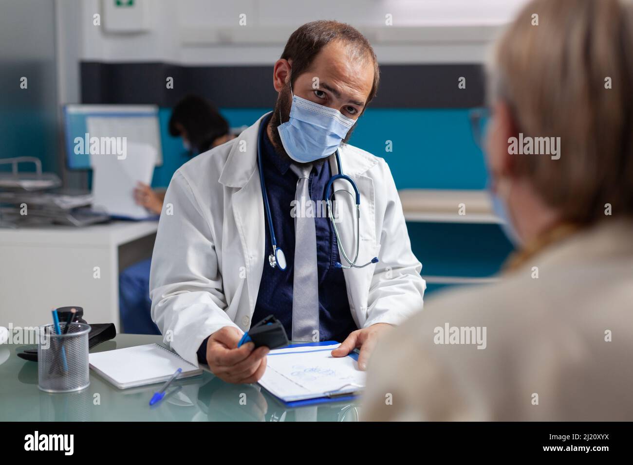 Doctor putting medical seal on prescription paper, giving medicine to ...