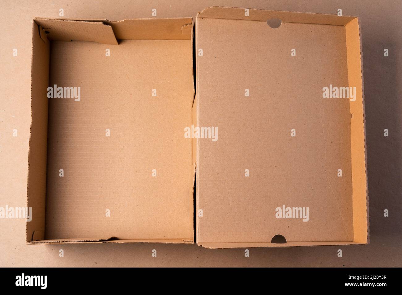 Cardboard box on beige background in studio Stock Photo - Alamy