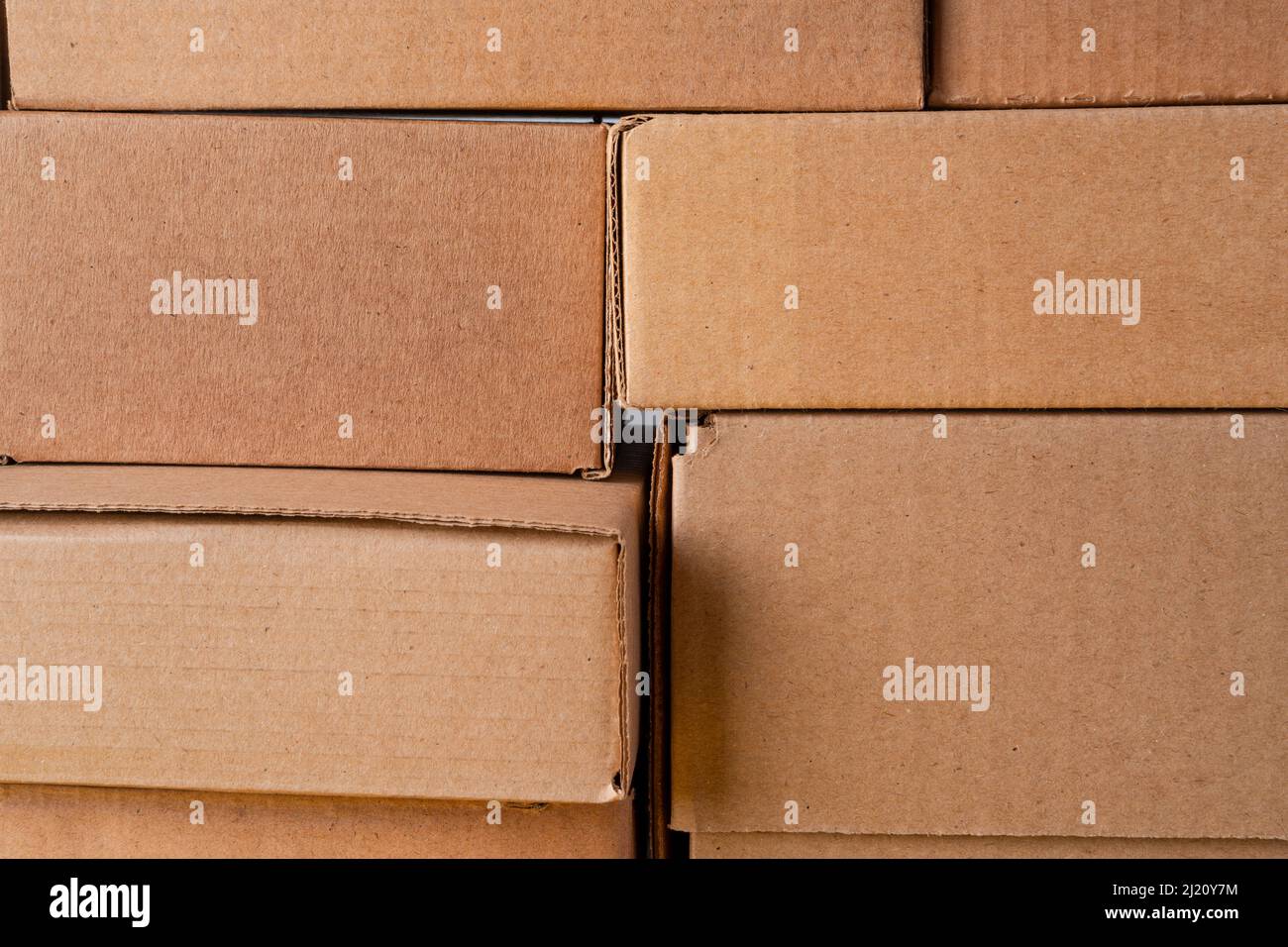 Cardboard boxes stacked in a pile as a background Stock Photo - Alamy