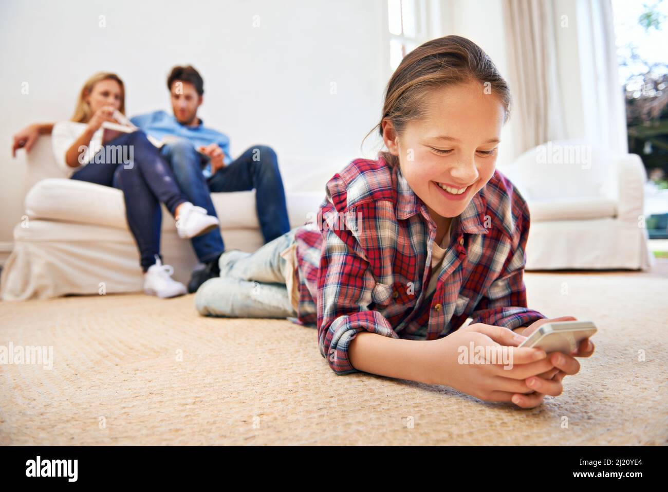 Together but separately entertained. Shot of a family relaxing at home ...
