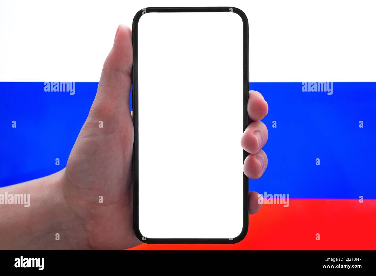 Hand with mobile phone mockup screen on Russian flag background. Mockup ...