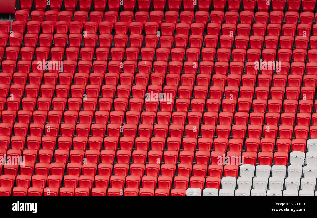 Rows of seats in a football stadium. Bright red and white stadium seats ...