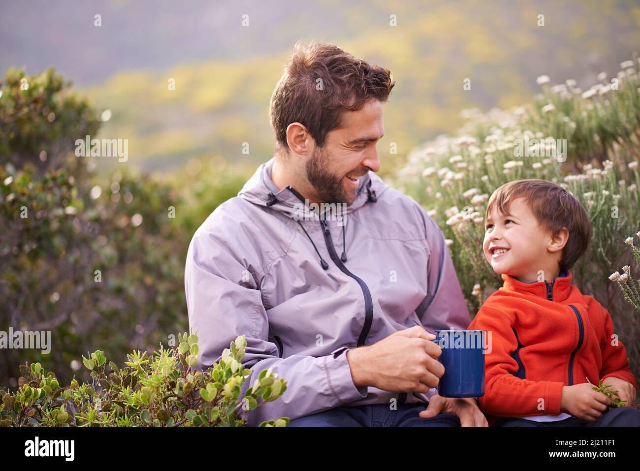 Bonding in the great outdoors. Shot of a happy father and son having ...
