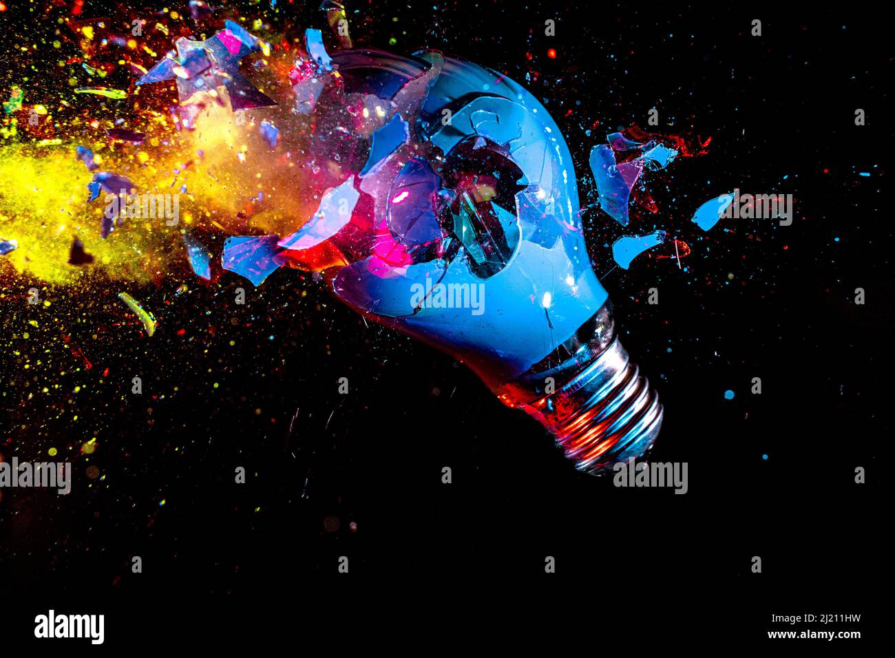 colorful electric light bulb exploding on black Stock Photo - Alamy