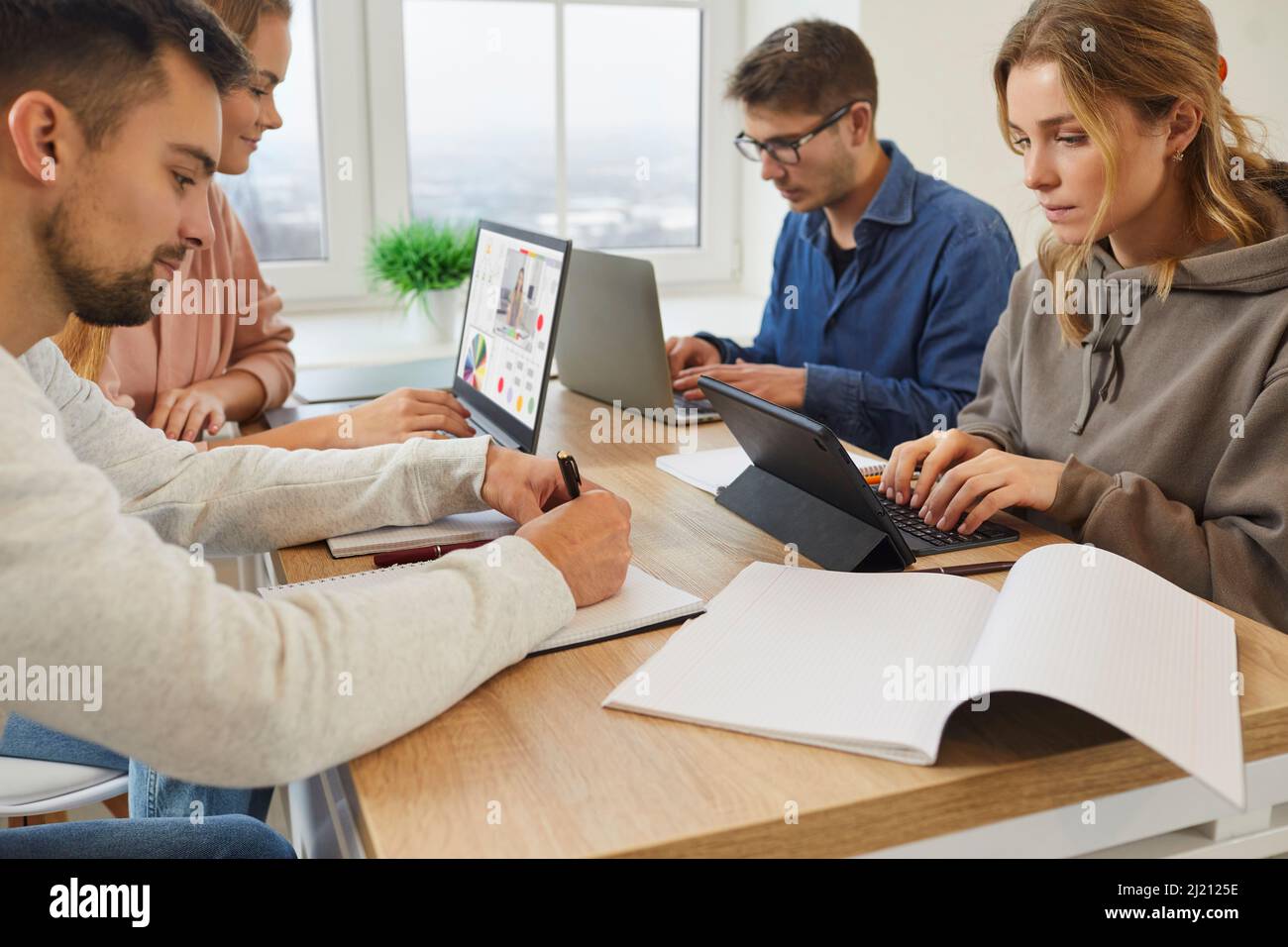 Diverse employees work on gadgets in office Stock Photo - Alamy