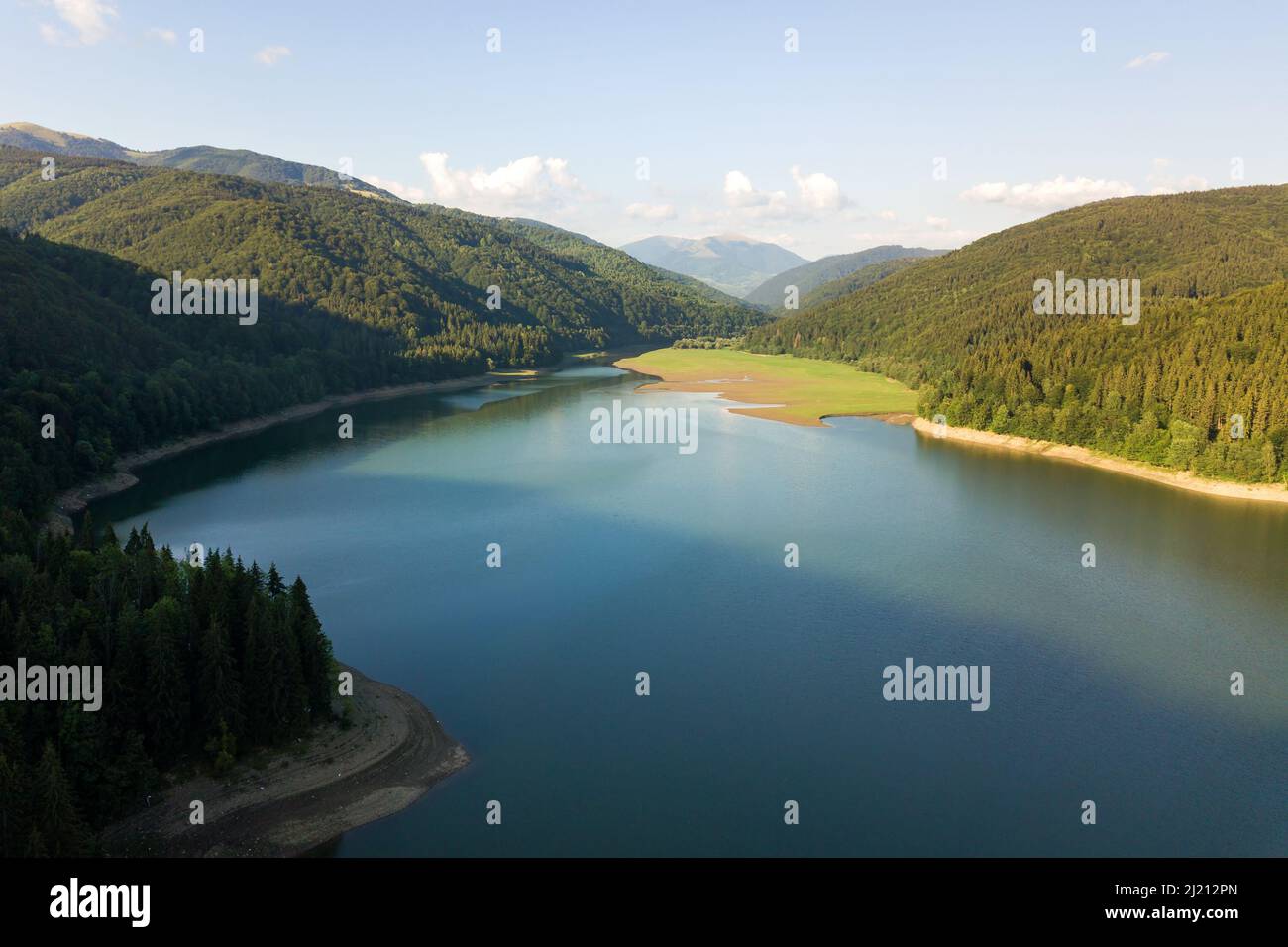 Aerial view of big lake with clear blue water between high mountain ...