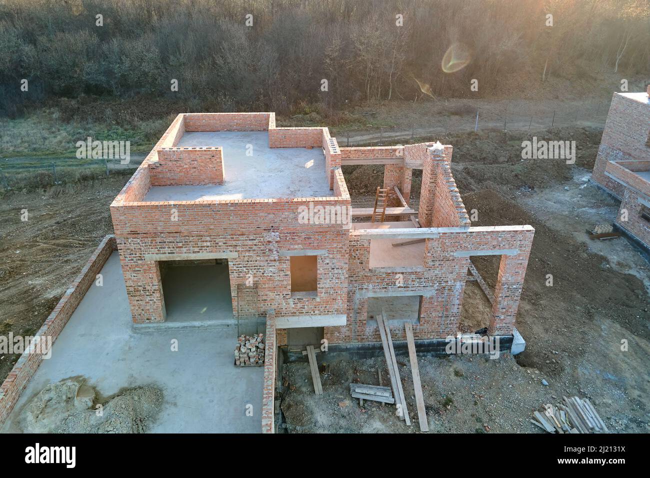 Aerial view of new homes with brick framework walls under construction ...