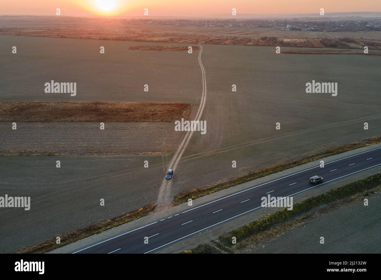 Aerial view of intercity road with fast driving cars at sunset. Top ...