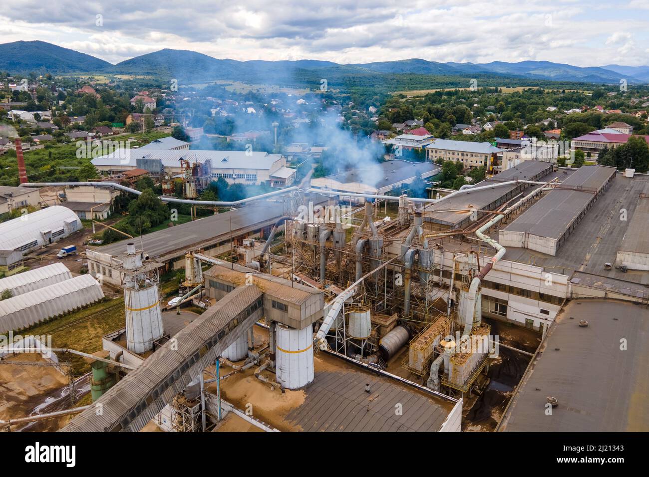 Aerial view of wood processing plant with smokestack from production ...
