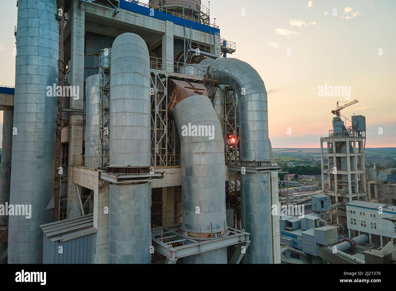 Cement plant with high factory structure and tower cranes at industrial ...