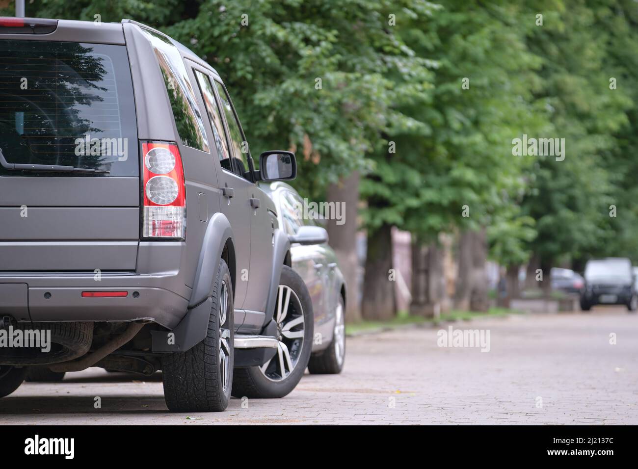 Cars parked in line on city street side. Urban traffic concept Stock ...