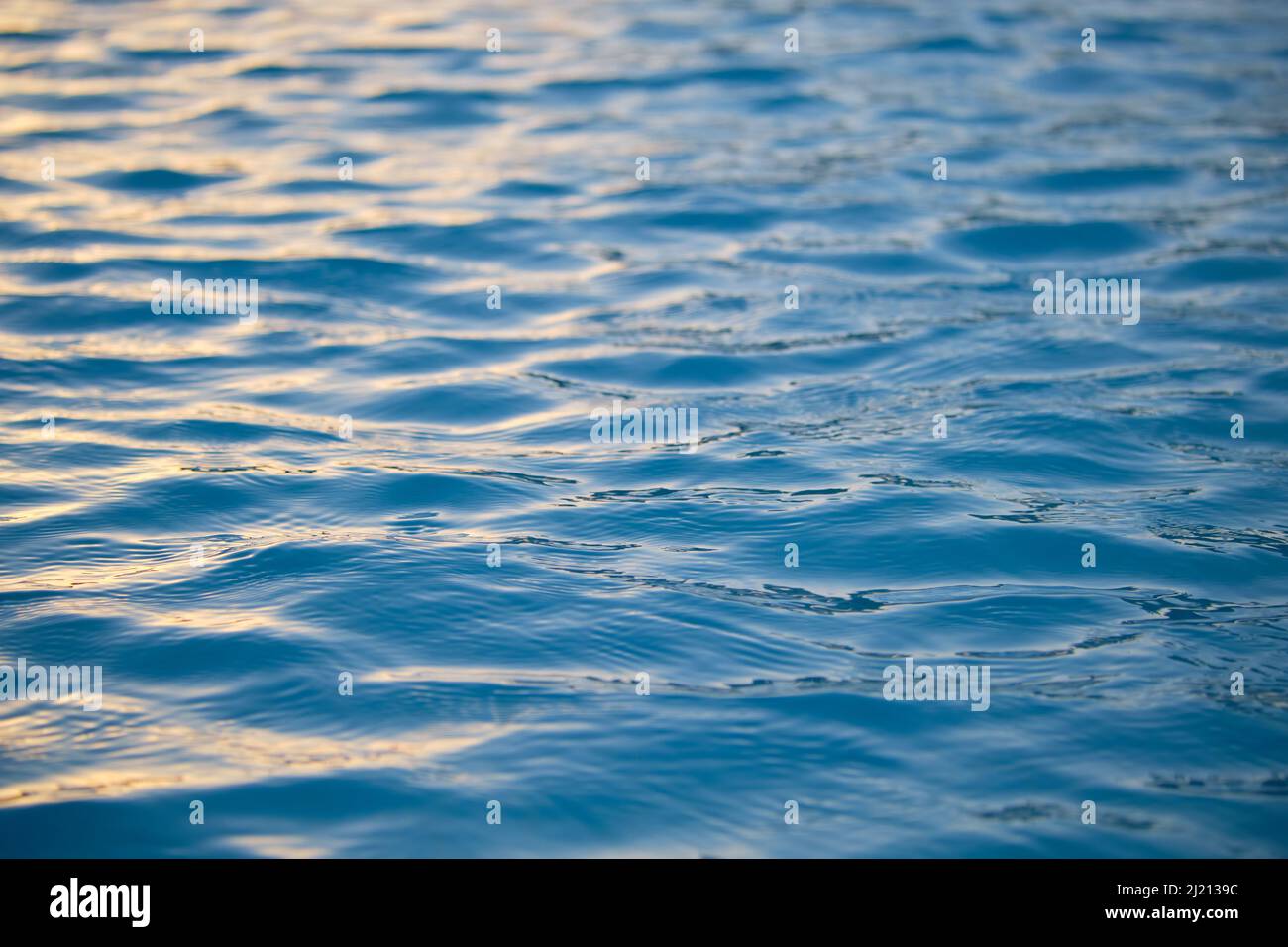 Closeup seascape surface of blue sea water with small ripple waves ...