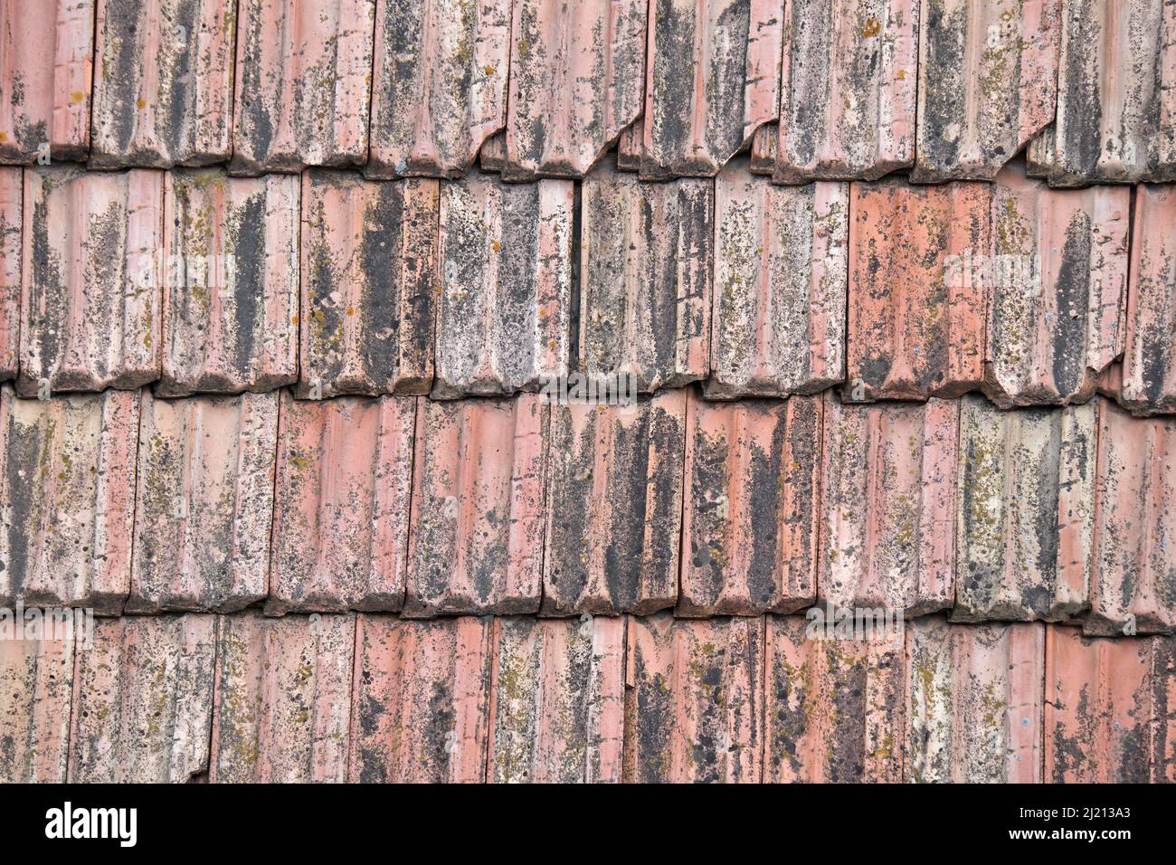 Closeup surface of old weathered ceramic tiles covering building roof ...