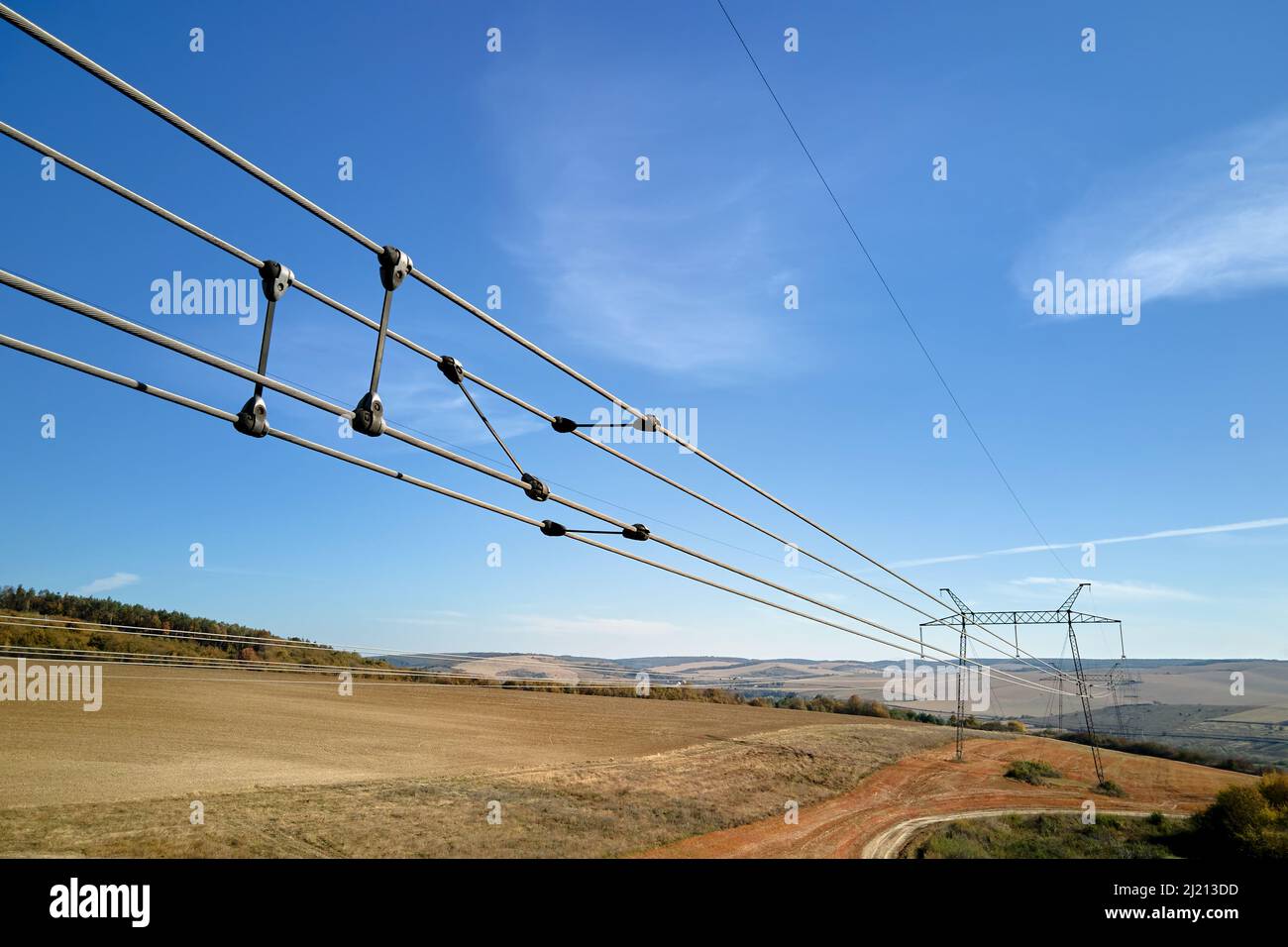 High voltage tower with electric power lines divided by safe guard ...