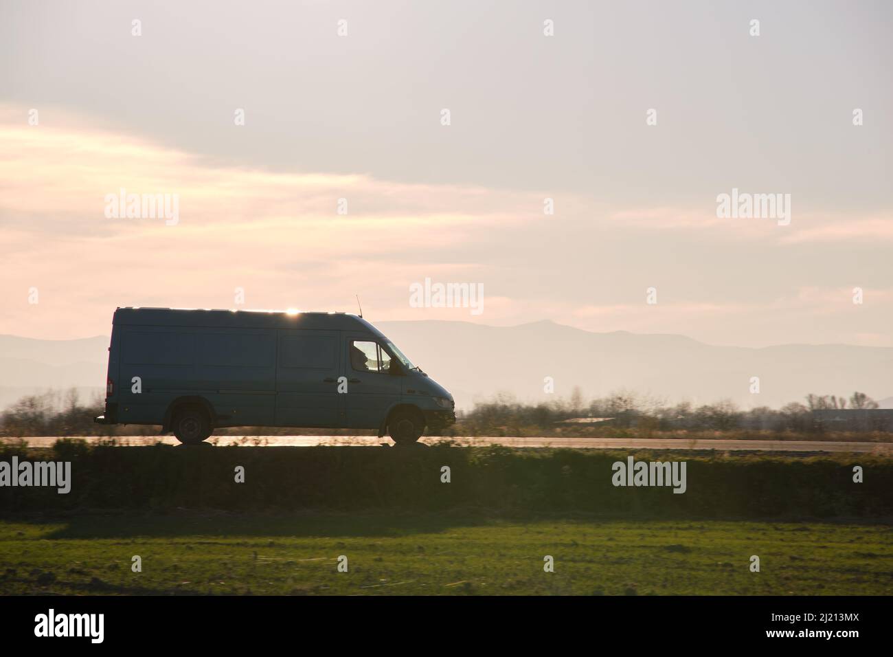 Small cargo van driving on highway hauling goods. Delivery ...