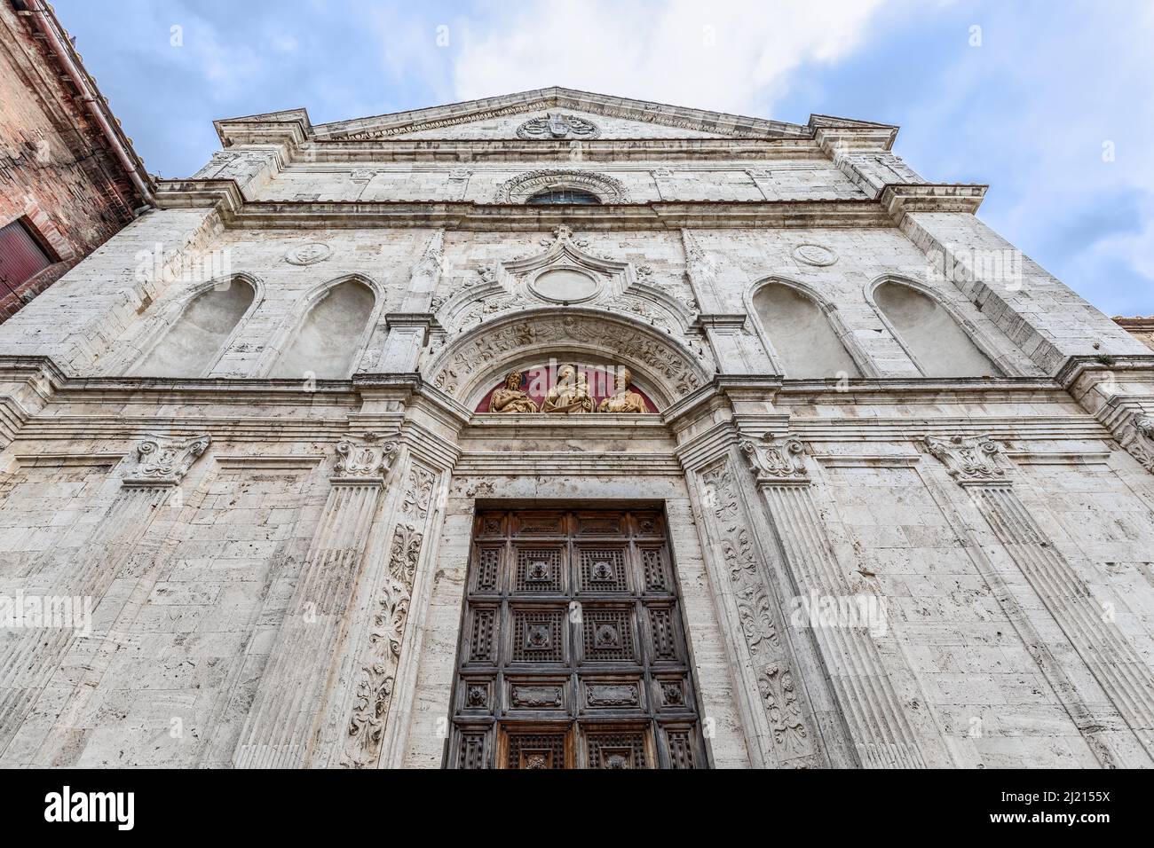 The marble facade with the terra-cotta relief in the tympanum above the ...