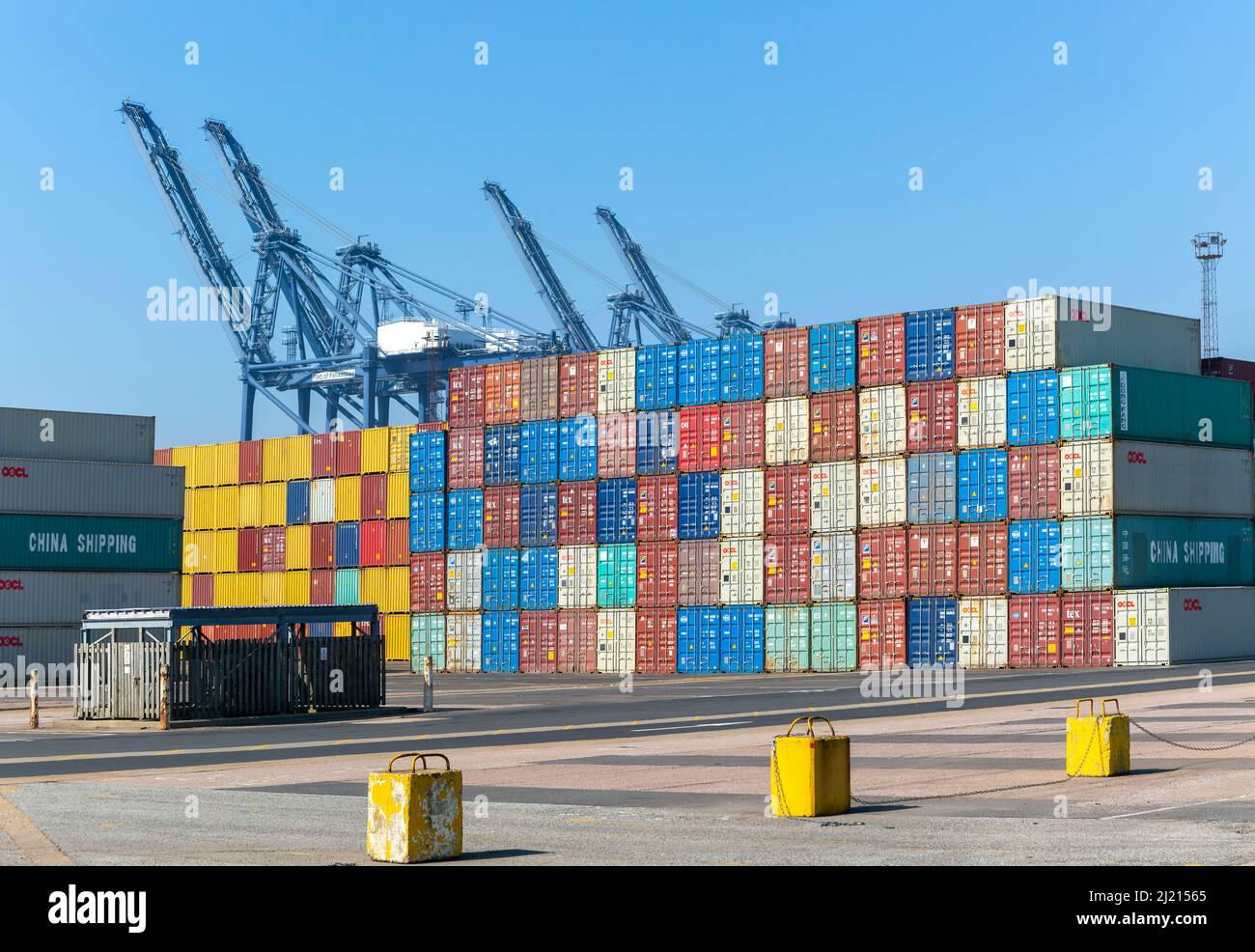 Gantry cranes and piles of shipping containers on quayside, Port of ...