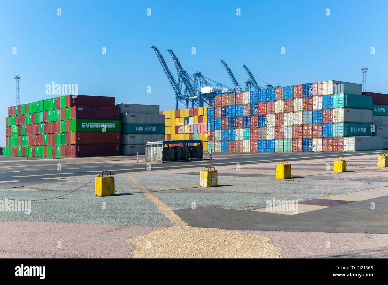 Gantry cranes and piles of shipping containers on quayside, Port of ...
