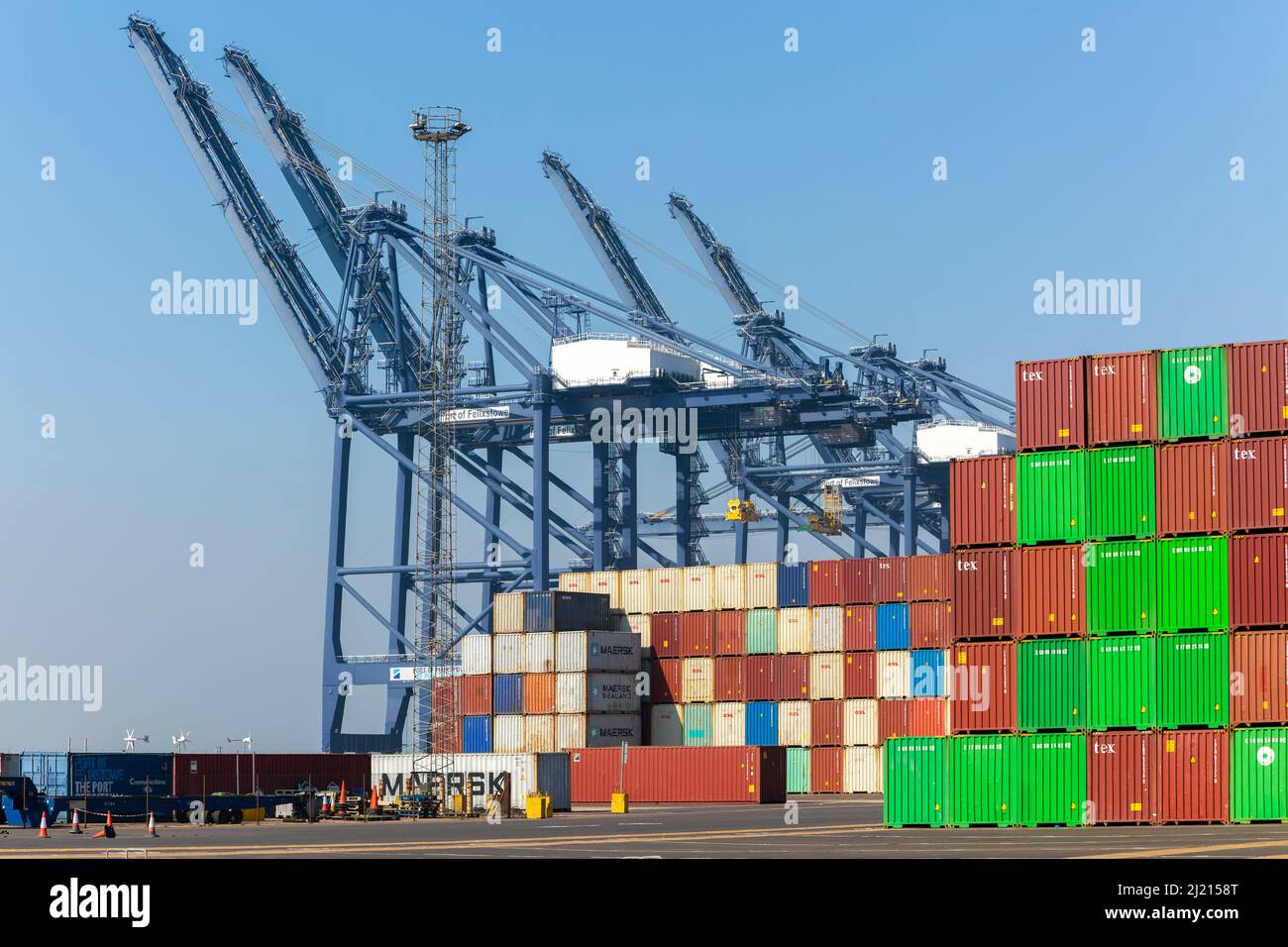 Gantry cranes and piles of shipping containers on quayside, Port of ...