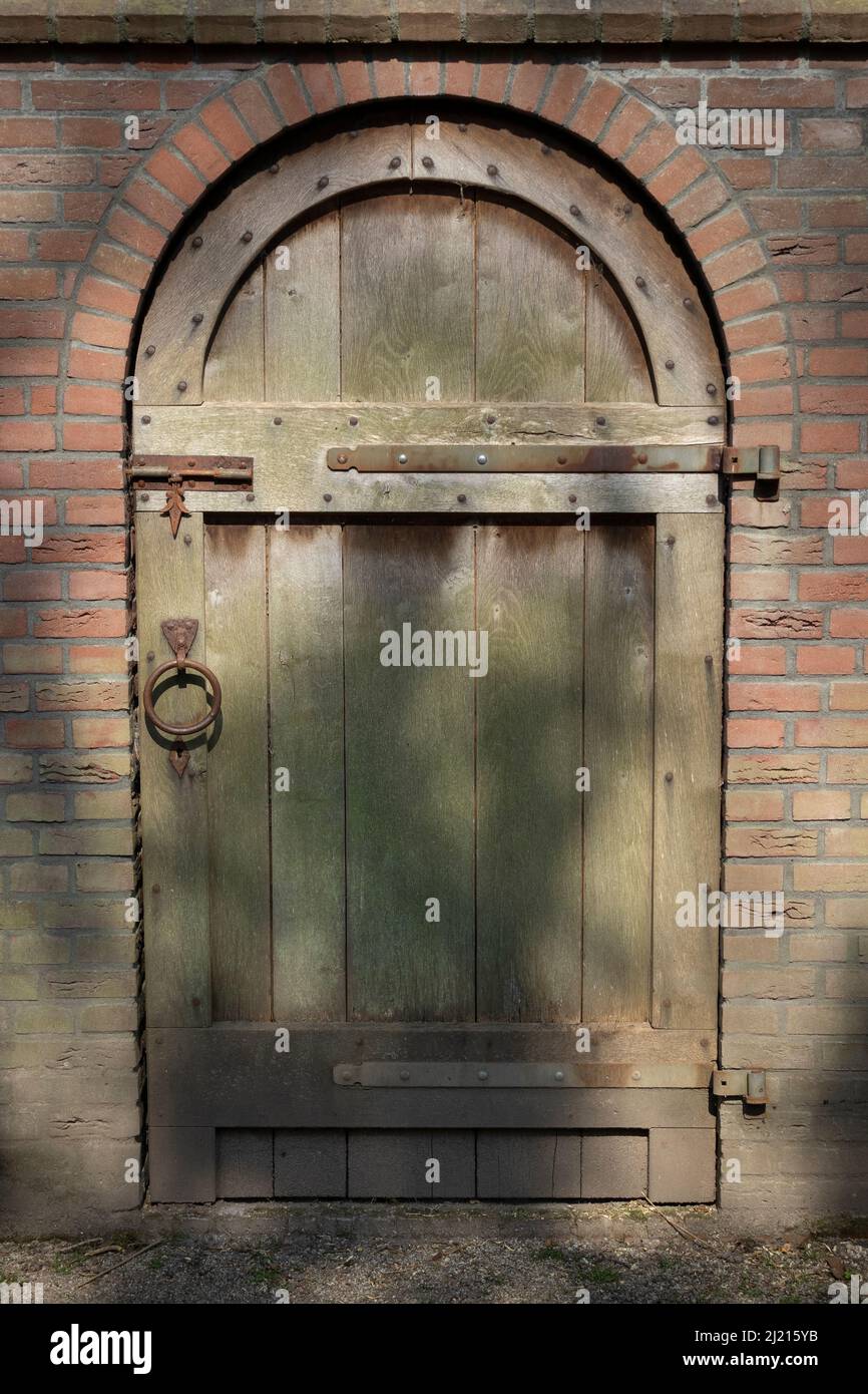 Old classic simple wooden door in a stone wall Stock Photo - Alamy