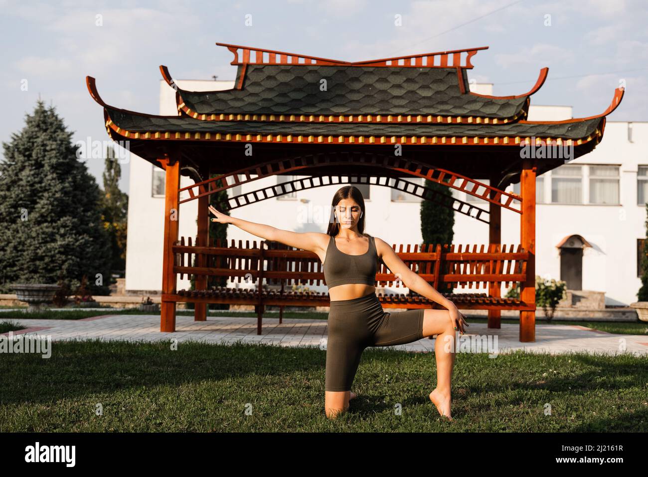 Qigong chinese meditation and sport training outdoor. Fit asian girl is ...