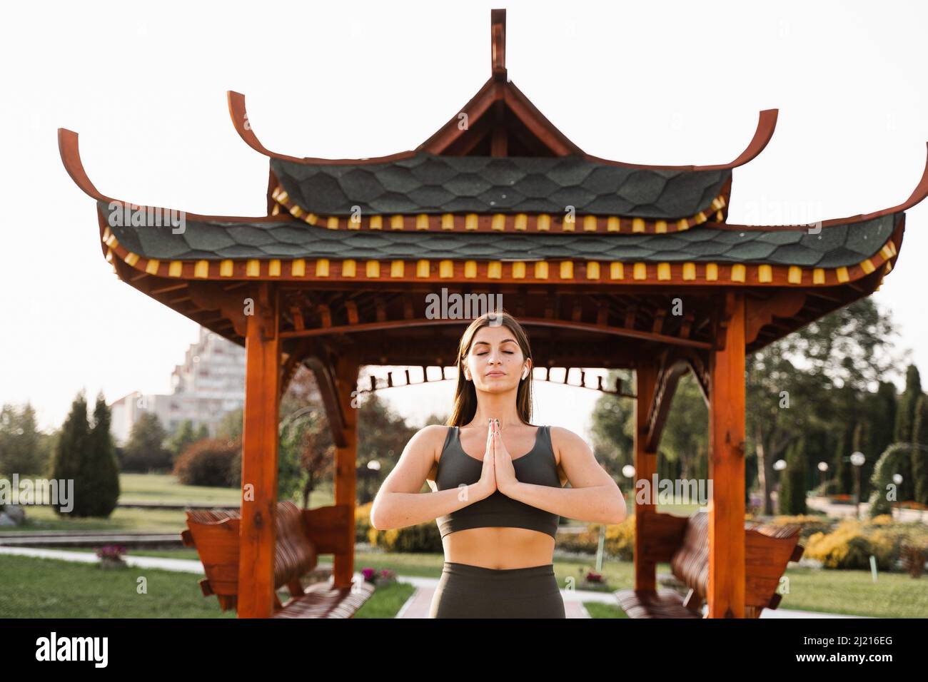 Qigong chinese meditation and sport training outdoor. Fit asian girl is ...