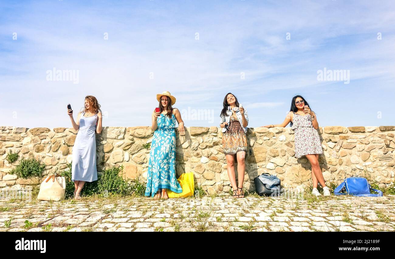 Young women girlfriends using smartphone outdoors with mutual ...