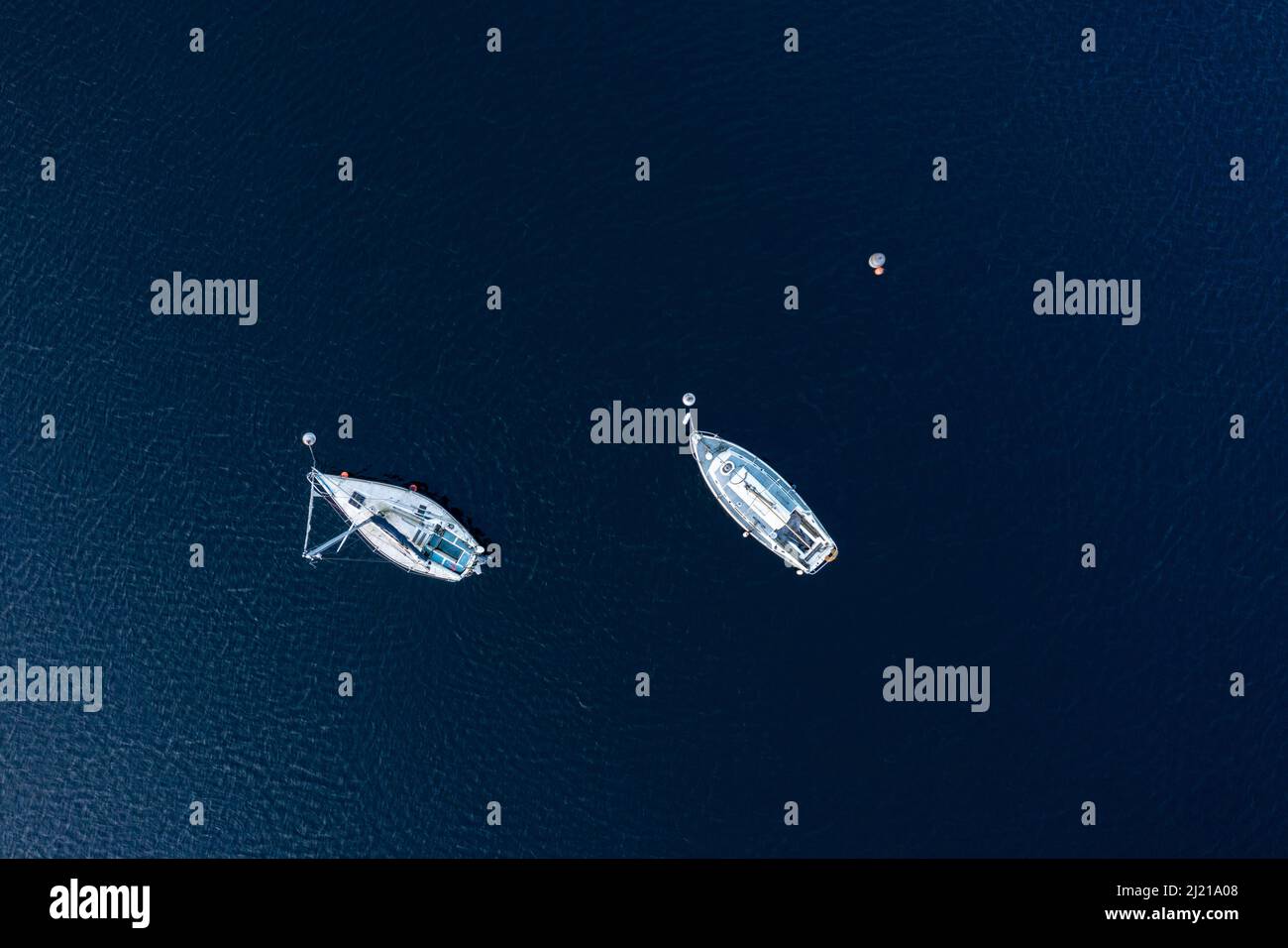 top down view of two sail boats moored on a lake Stock Photo - Alamy
