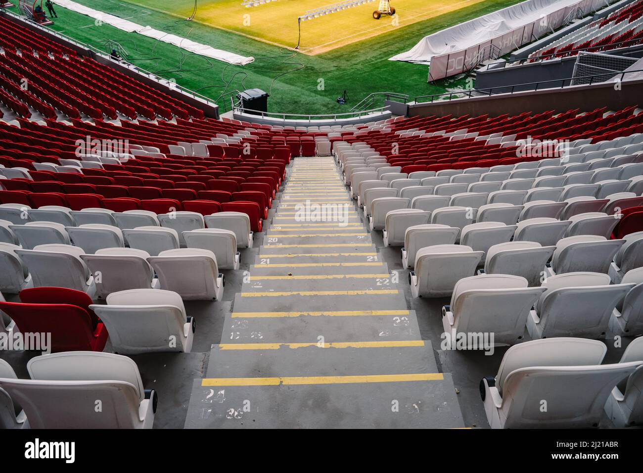 Descending onto the stadium football pitch. Stairs between rows of ...