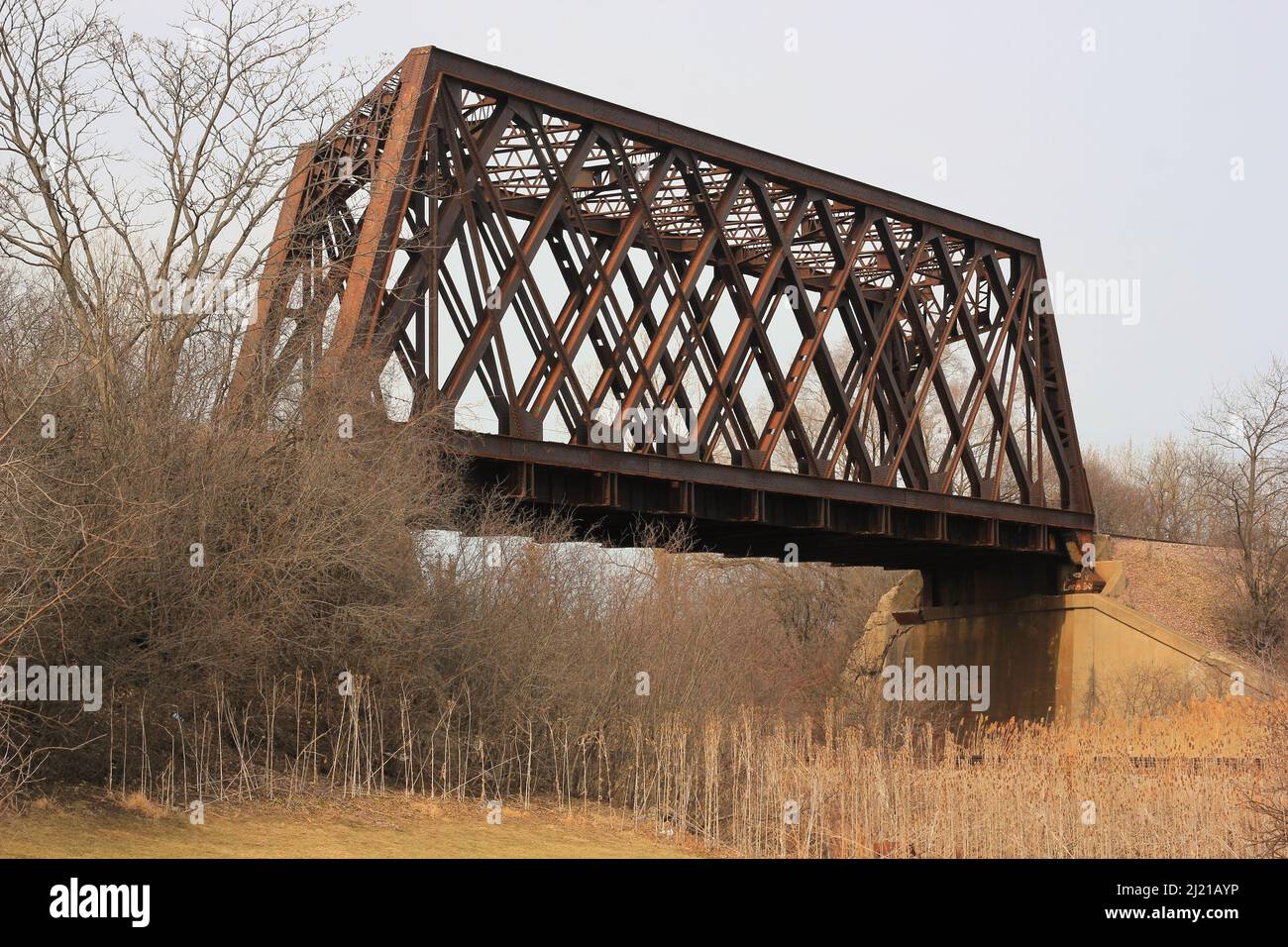 Vintage old rusty truss bridge spanning another set of railroad tracks ...