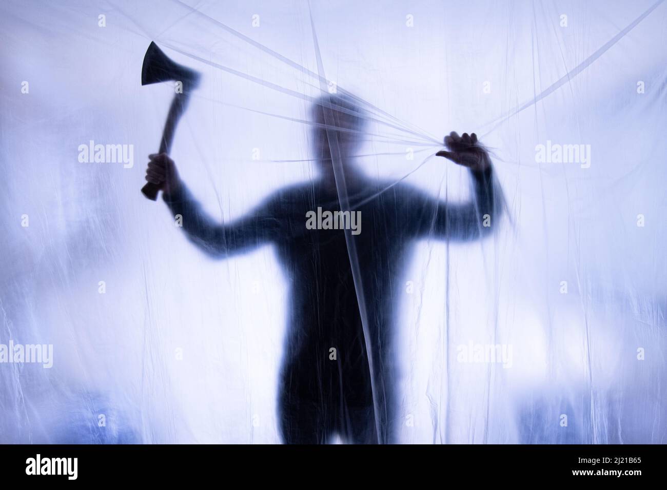 Horror: Fear the Psychopath murder with an axe behind foil Stock Photo ...