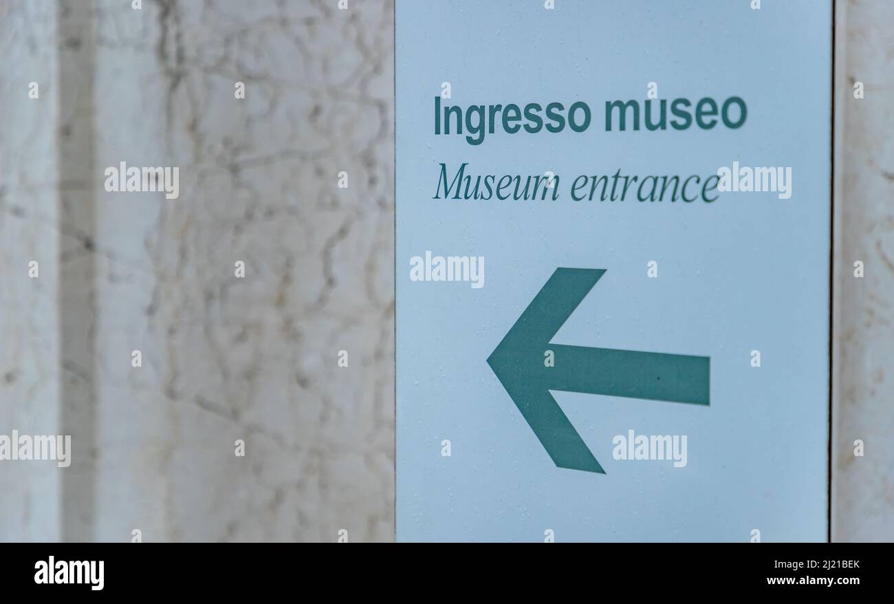 A picture of a museum entrance sign written in English and Italian ...