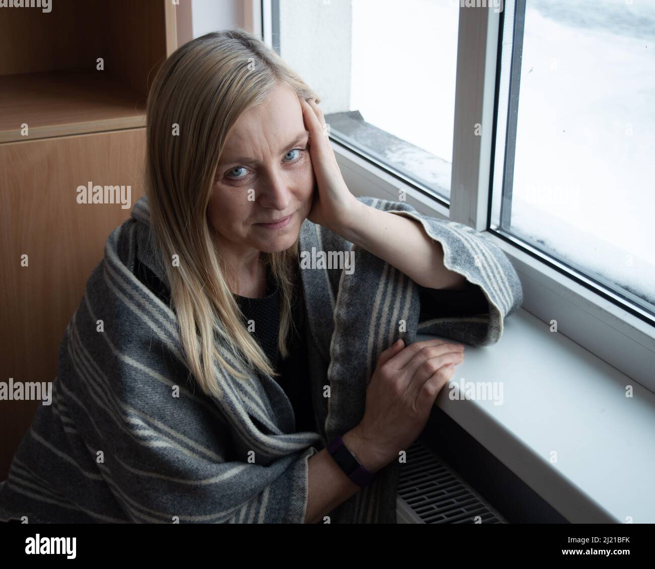 Portrait of a woman at the window in winter Stock Photo - Alamy