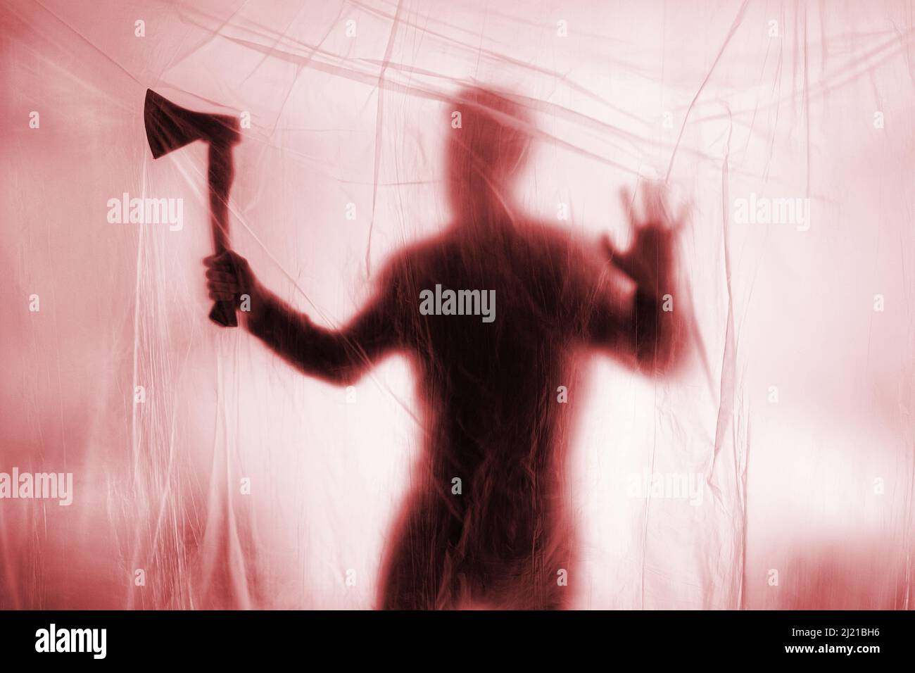 Horror: Fear the Psychopath murder with an axe behind foil Stock Photo ...