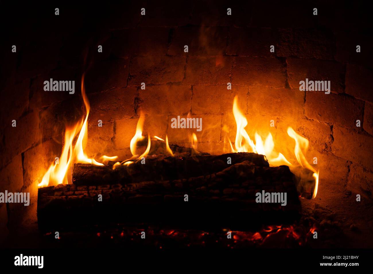 Burning fireplace, wood logs, cozy warm home Stock Photo - Alamy