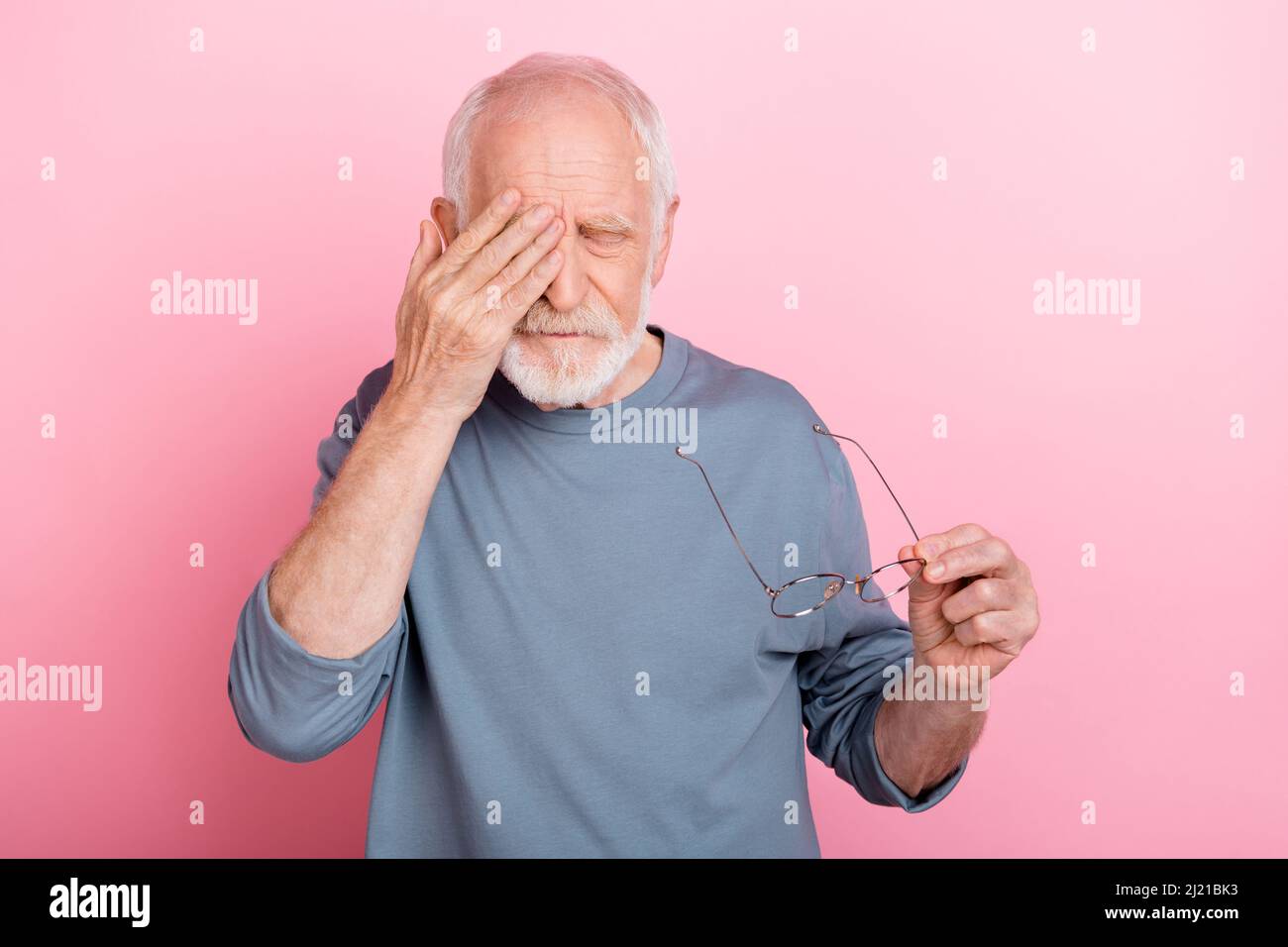 Photo of tired upset retired man grey sweater smiling holding ...