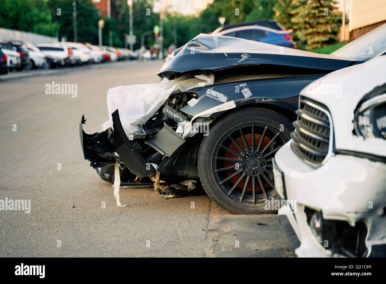 Crashed modern cars on city parking Stock Photo - Alamy