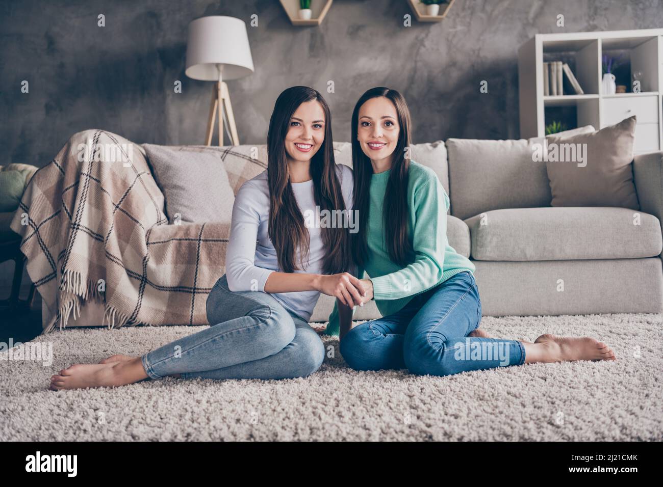 Portrait of two attractive cheerful people friends family sitting on ...