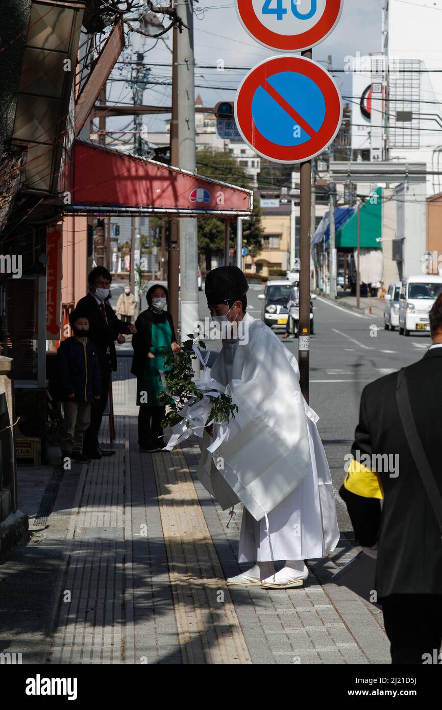 iida, nagano, japan, 2022/24/03 , Shintoist priest bowing in front of a ...