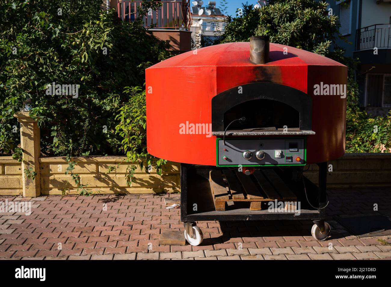 Large domed red metal outdoor pizza oven Stock Photo - Alamy