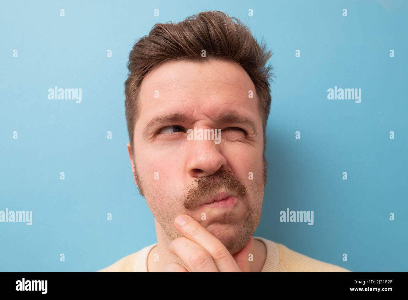 man with funny mustache having doubts and with confuse face expression ...