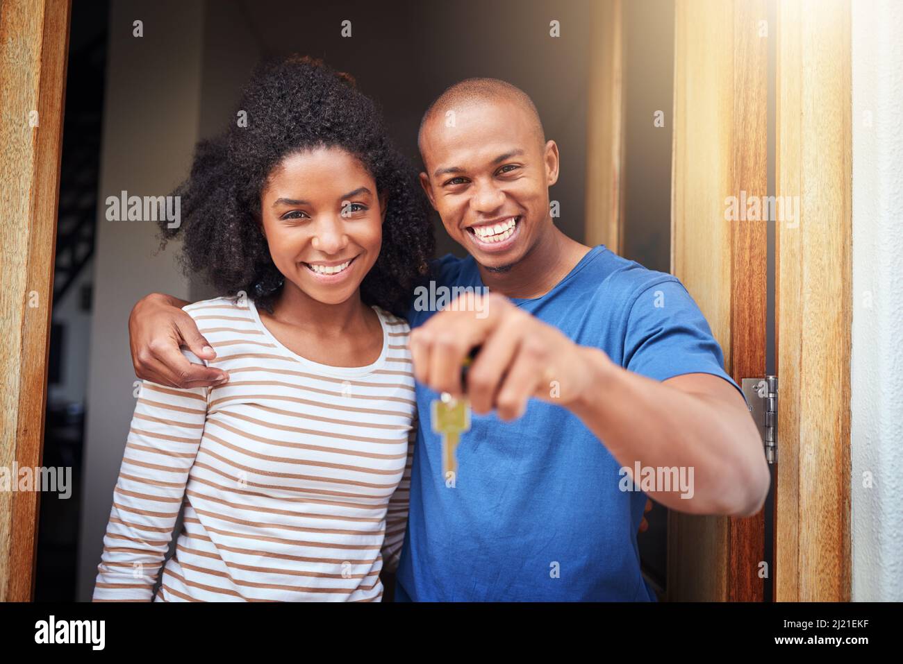 Welcome to our new home. Portrait of a cheerful young couple standing ...